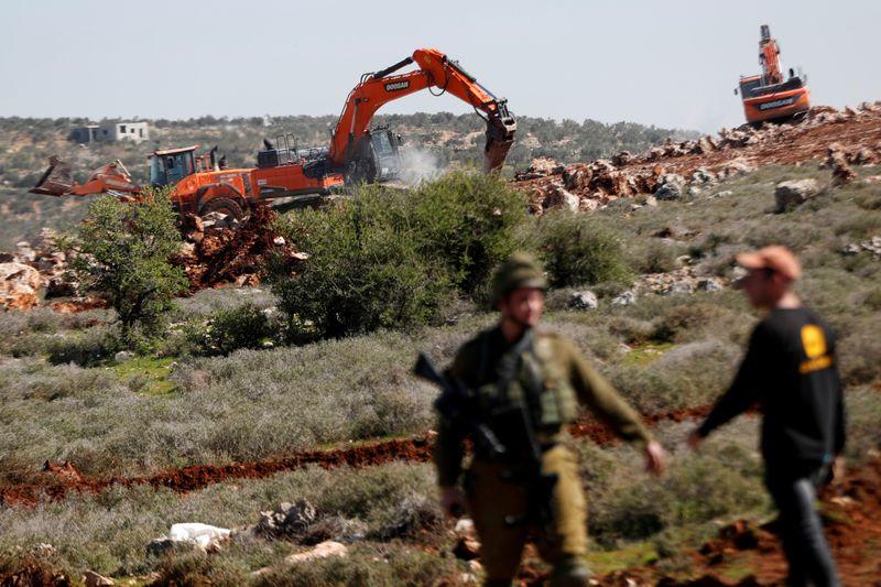 Palestinians protest as Israeli bulldozers clear land